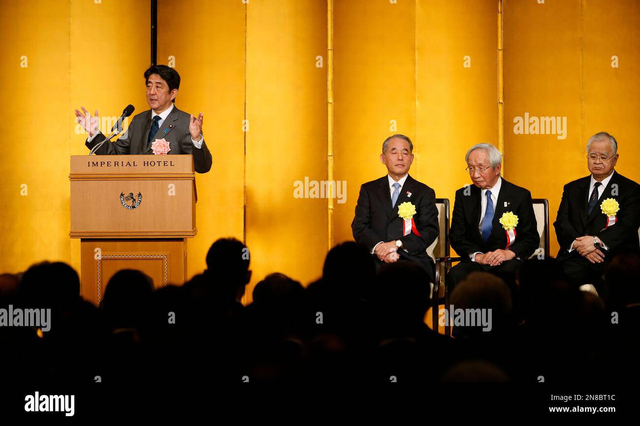 Japanese Prime Minister Shinzo Abe, left, speaks as Japan Association ...