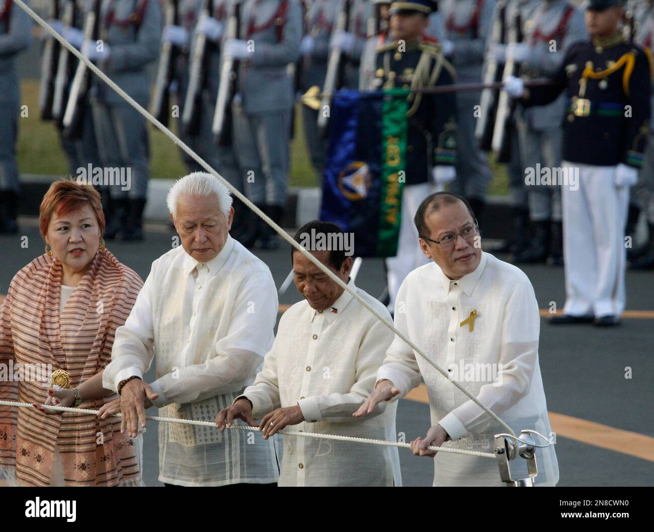 Philippine President Benigno Aquino III, right, pulls the rope as he ...