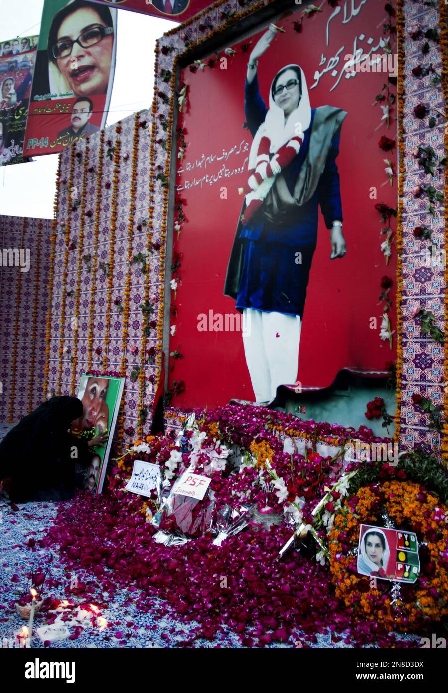 A supporter of Pakistan's assassinated leader Benazir Bhutto sits near ...