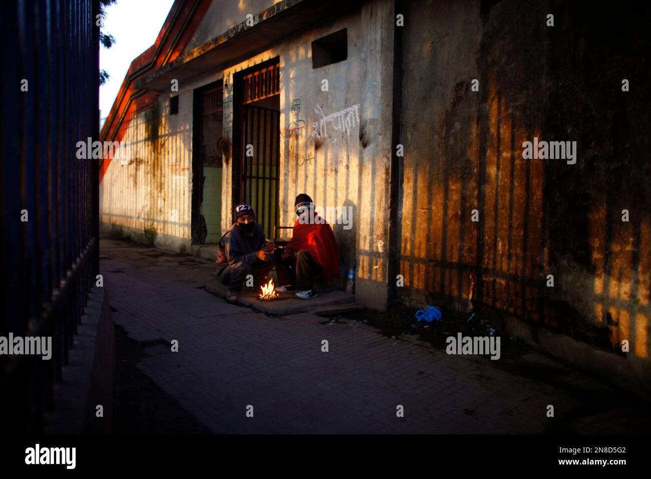 Nepalese men sit around a bonfire in Katmandu, Nepal, Wednesday, Dec ...