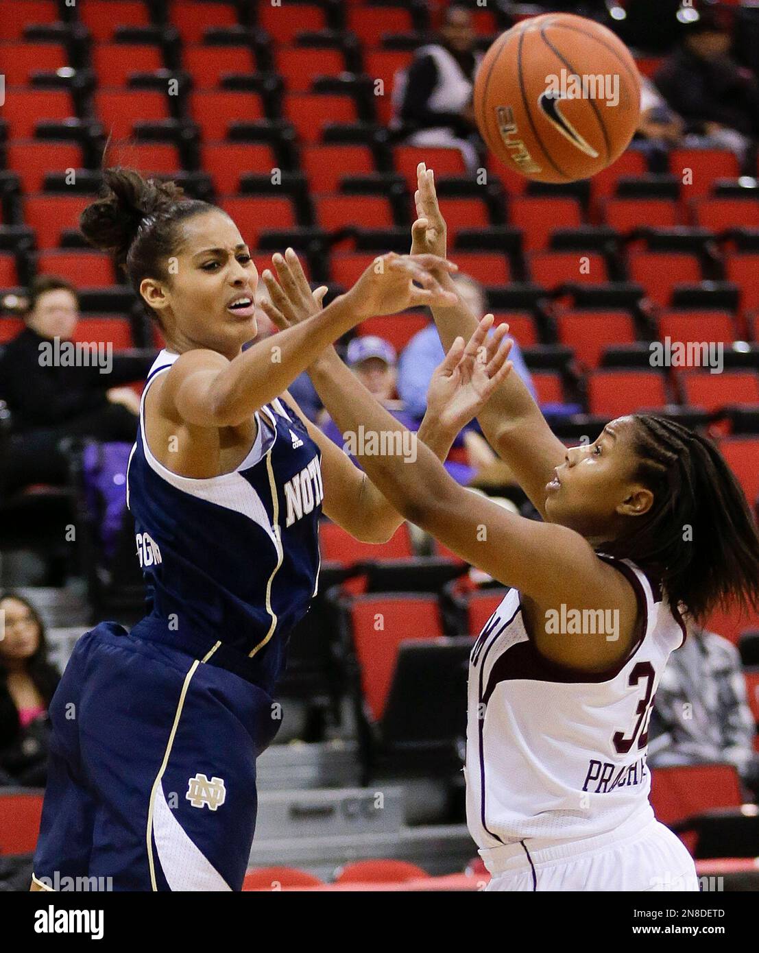 Notre Dame's Skylar Diggins, left, passes the ball over Texas A&M's ...