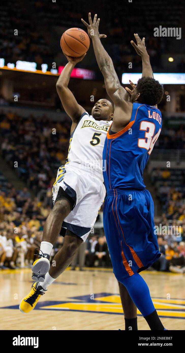 Marquette's Junior Cadougan shoots a fade away jump shot over Savannah ...