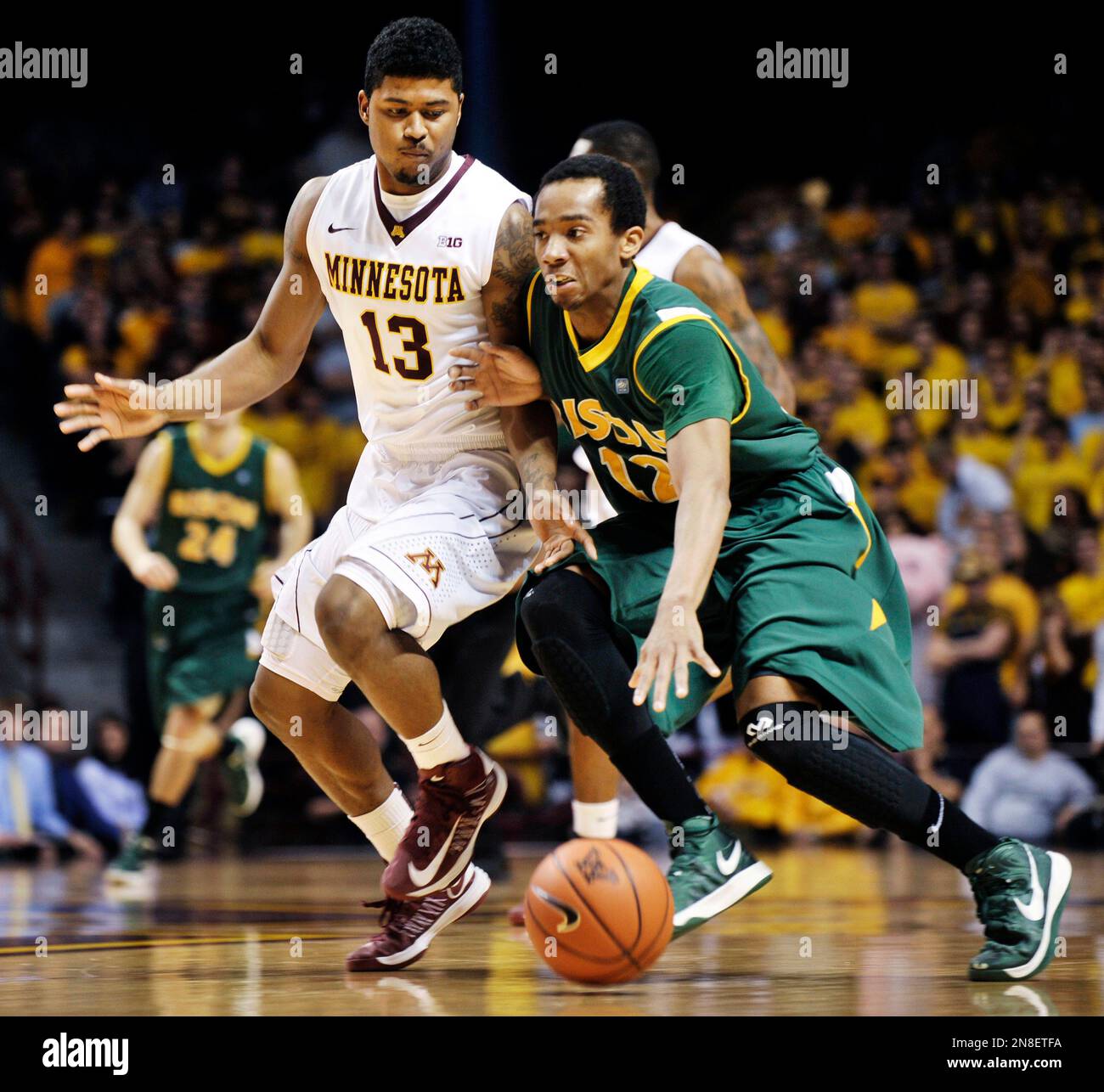 North Dakota State's Lawrence Alexander, right, attempts to drive ...