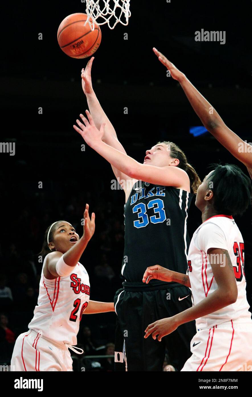 Duke's Haley Peters, (33) shoots against St. John's Keylantra Langley ...