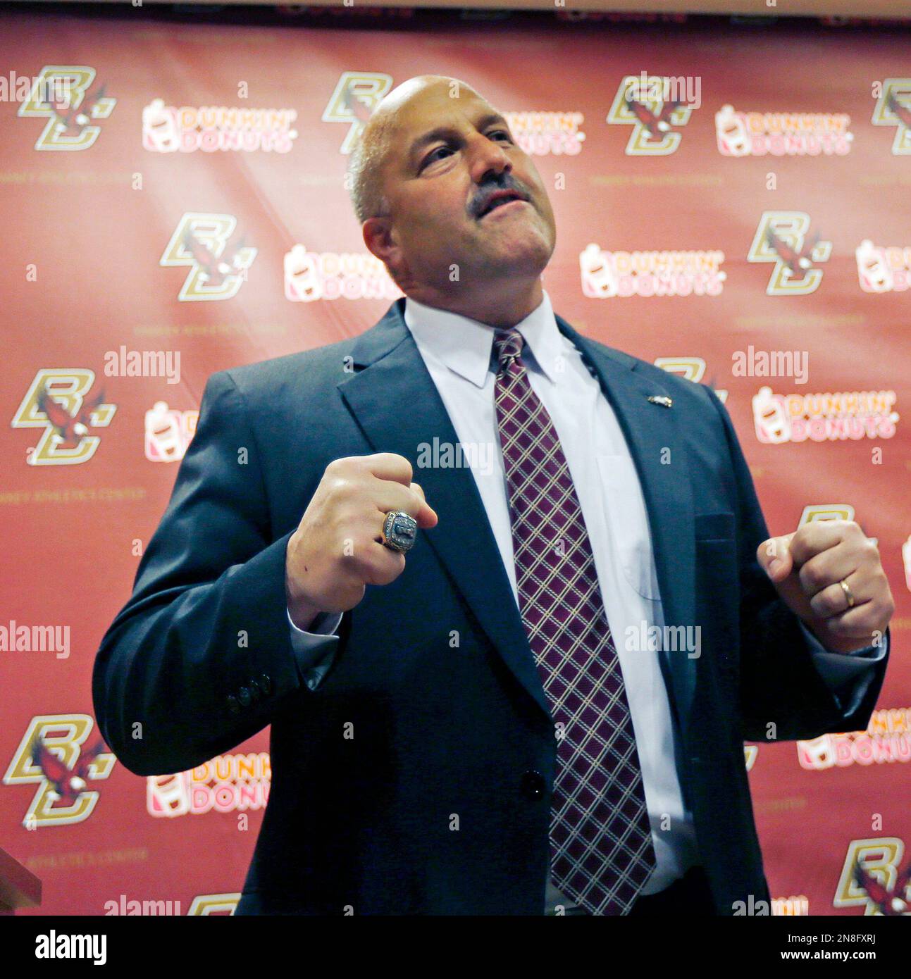 Steve Addazio raises his fists during a news conference where he was ...