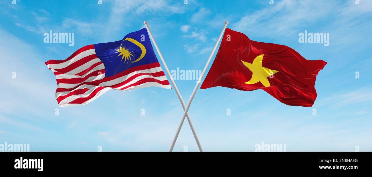 Zwei gekreuzte Flaggen Vietnam und Malaysia, die im Wind am bewölkten ...