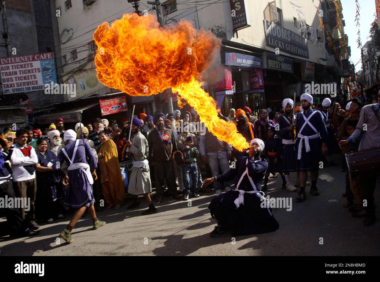 An Indian Sikh blows fire during a procession to mark the birth ...
