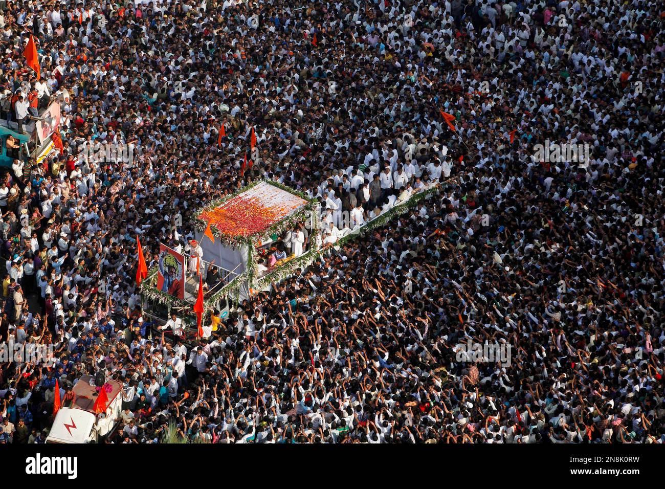 Indian mourners gather beside a truck carrying the body of Hindu ...