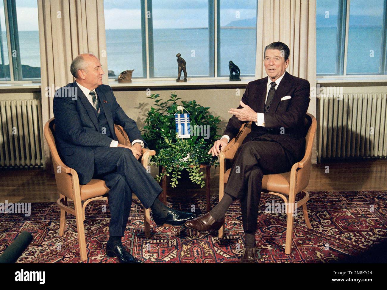 Soviet leader Mikhail Gorbachev and U.S. President Ronald Reagan sit ...