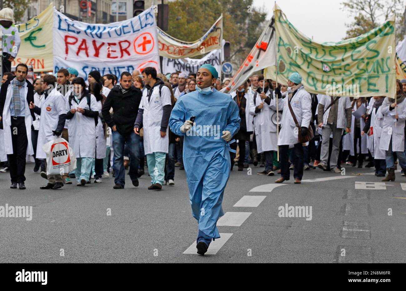 Hundreds of French doctors, many wearing white lab coats and blue ...