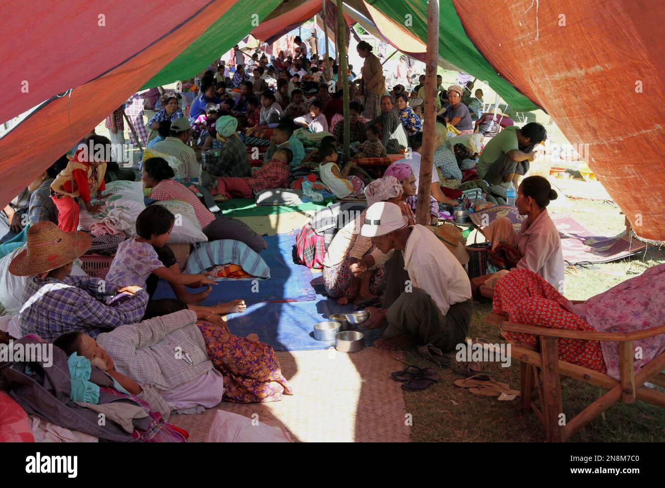People take refuge at a temporary shelter following Sunday's strong ...