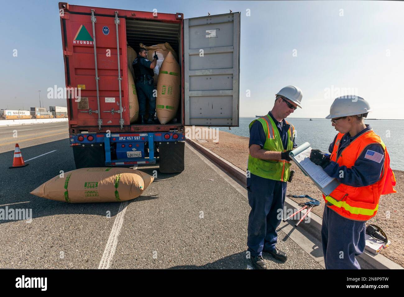 U.S. Coast Guard inspector, David Rice, center, and Coast Guard Petty ...