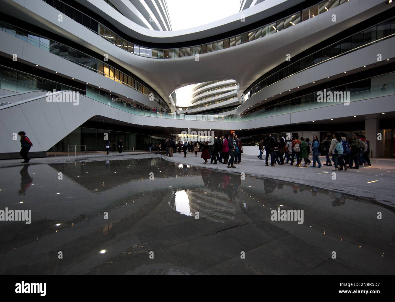 Visitors tour the newly opened Galaxy Soho building in Beijing Saturday ...