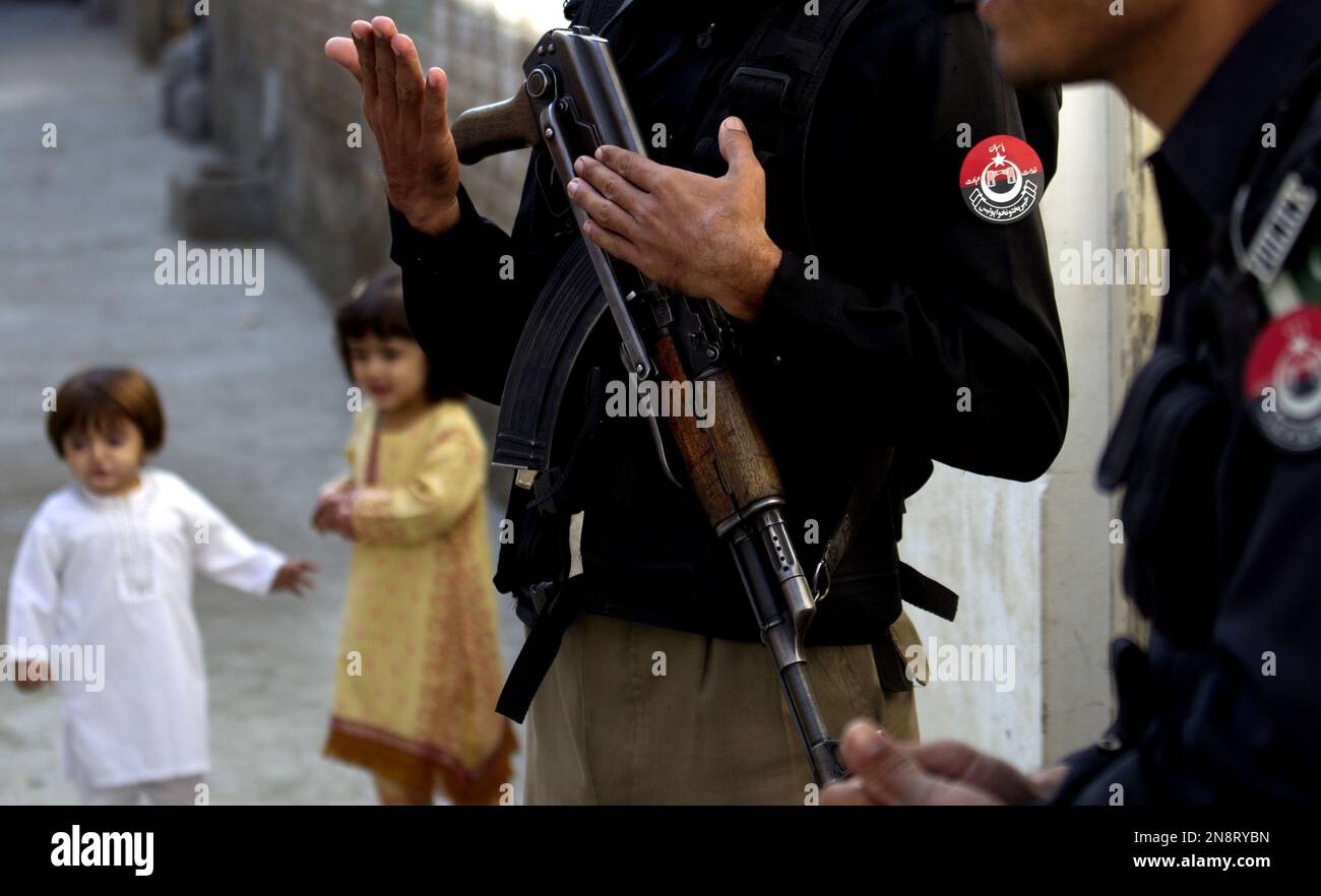 In this Thursday, Oct. 18, 2012 photo, Pakistani police officers stand ...