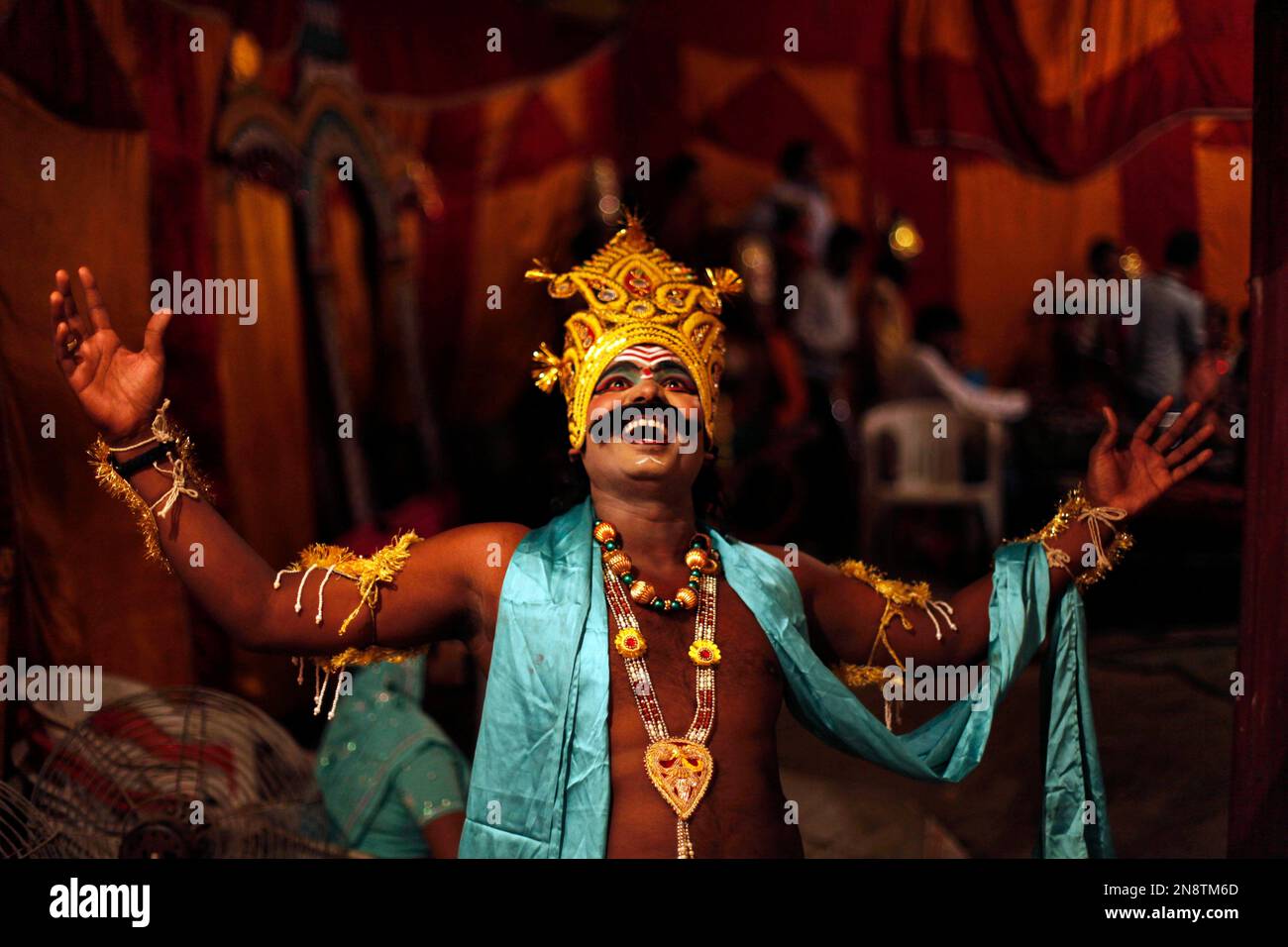 An artists in the role of demon king Ravana performs the traditional ...