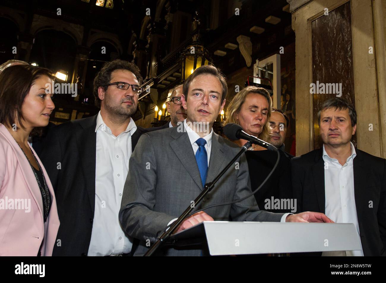 Leader of the NVA party Bart De Wever, center, addresses the media at ...