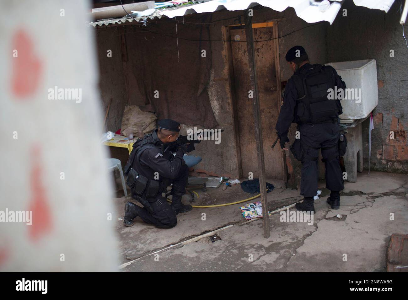 Police officers patrol the Maguinhos slum during an operation to ...