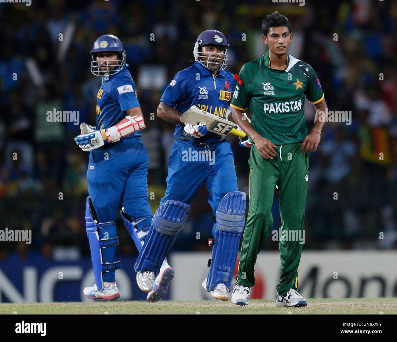 Pakistan's bowler Raza Hasan, right watches as Sri Lanka's captain ...