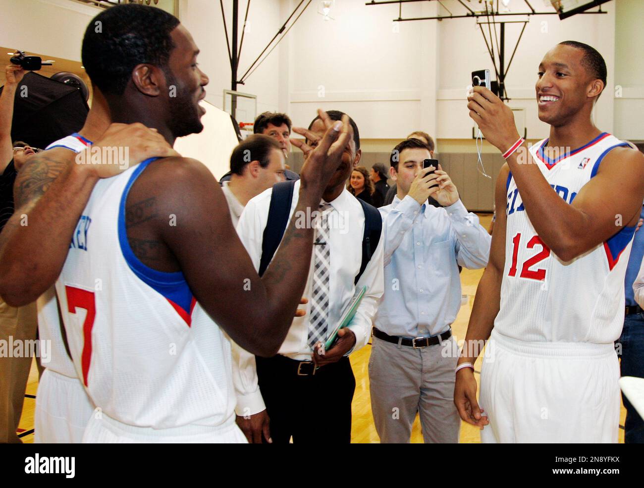 Philadelphia 76ers' Royal Ivey, left, and Xavier Silas, obscured, pose ...