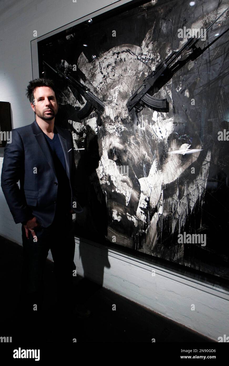 Artist Antony Micallef poses by his interpretation of an AK-47 assault ...
