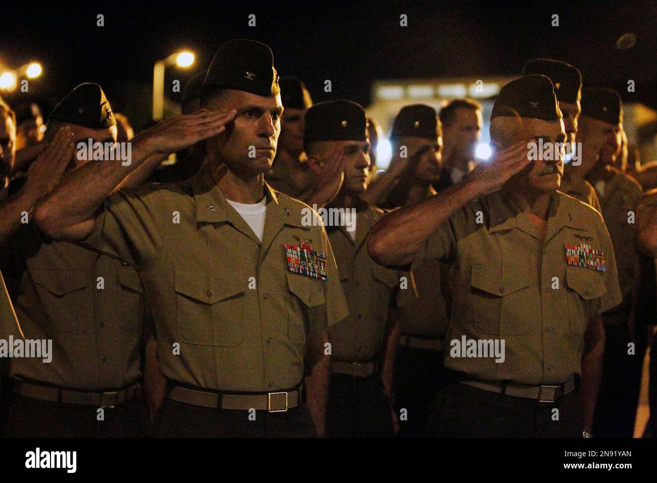 Marines from various aviation units salute as a Marine carry team moves ...