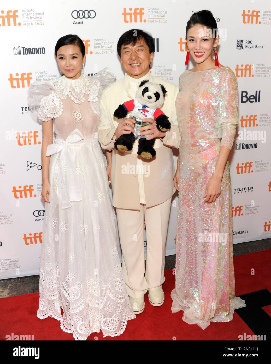 Chinese actresses Yao Xingtong, left, and Zhang Lanxin pose with actor Jackie Chan arrive at "In ...