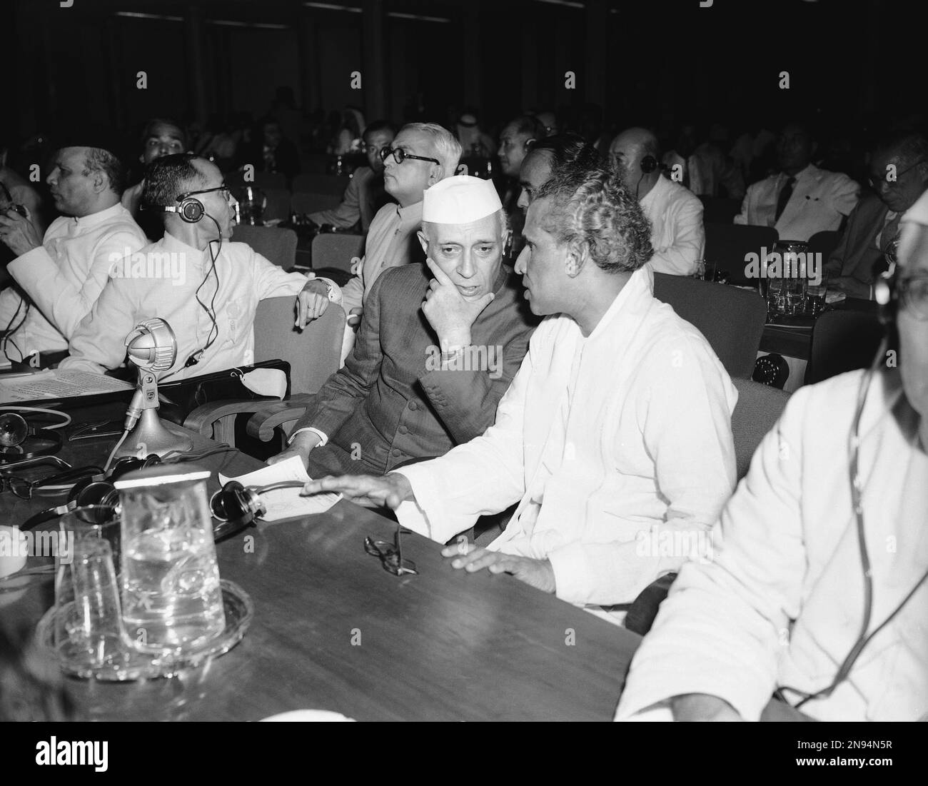 Indian Prime Minister Jawaharlal Nehru, at left, tucks his chin in his ...