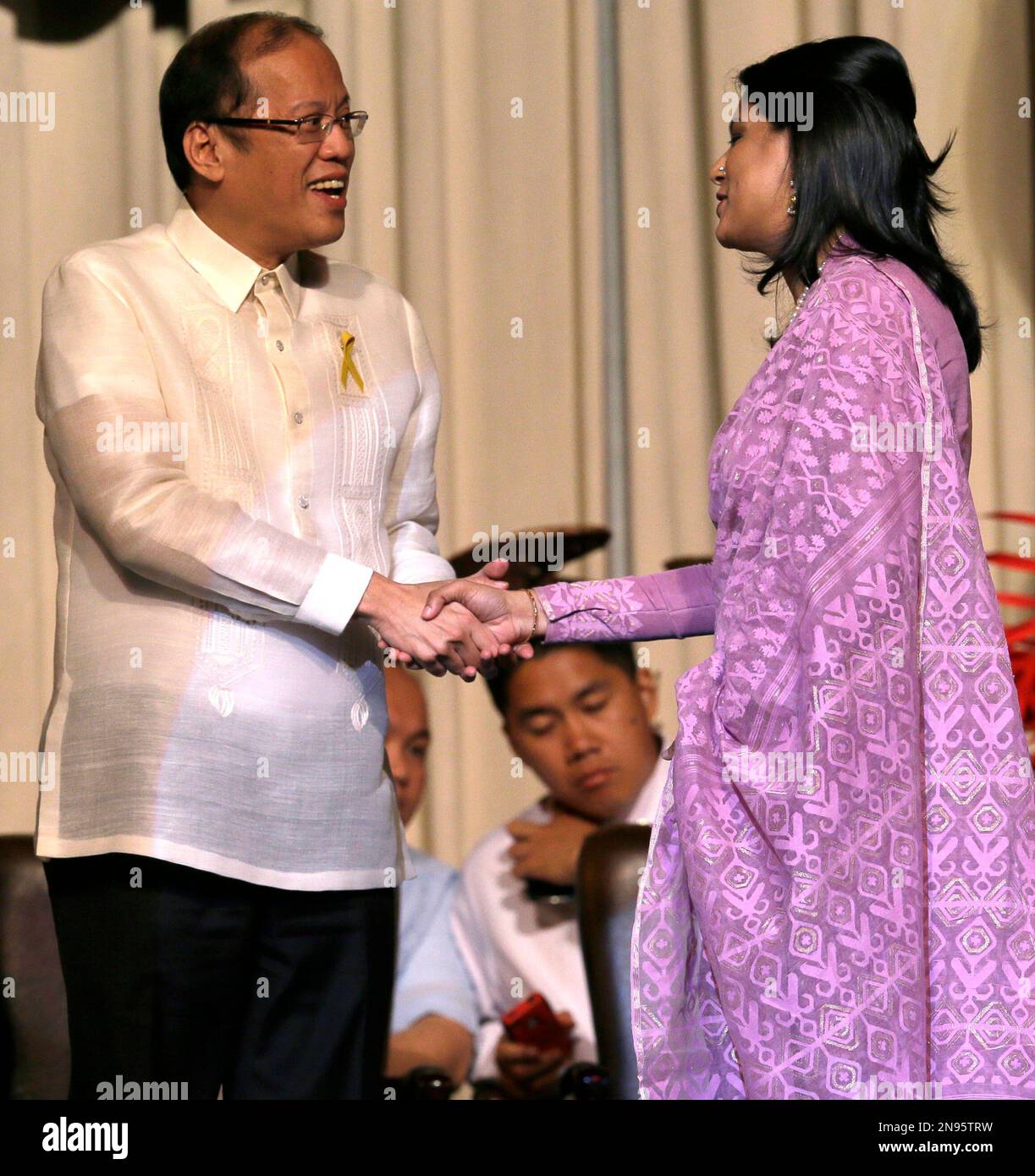 Philippine President Benigno Aquino III, left, presents a medallion to ...