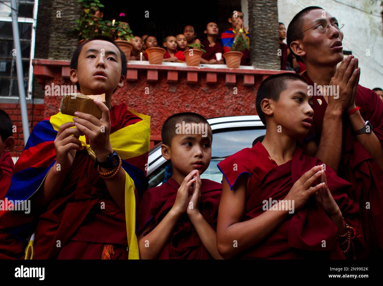 Exile Tibetan Buddhist monks participate in a candlelit vigil to ...