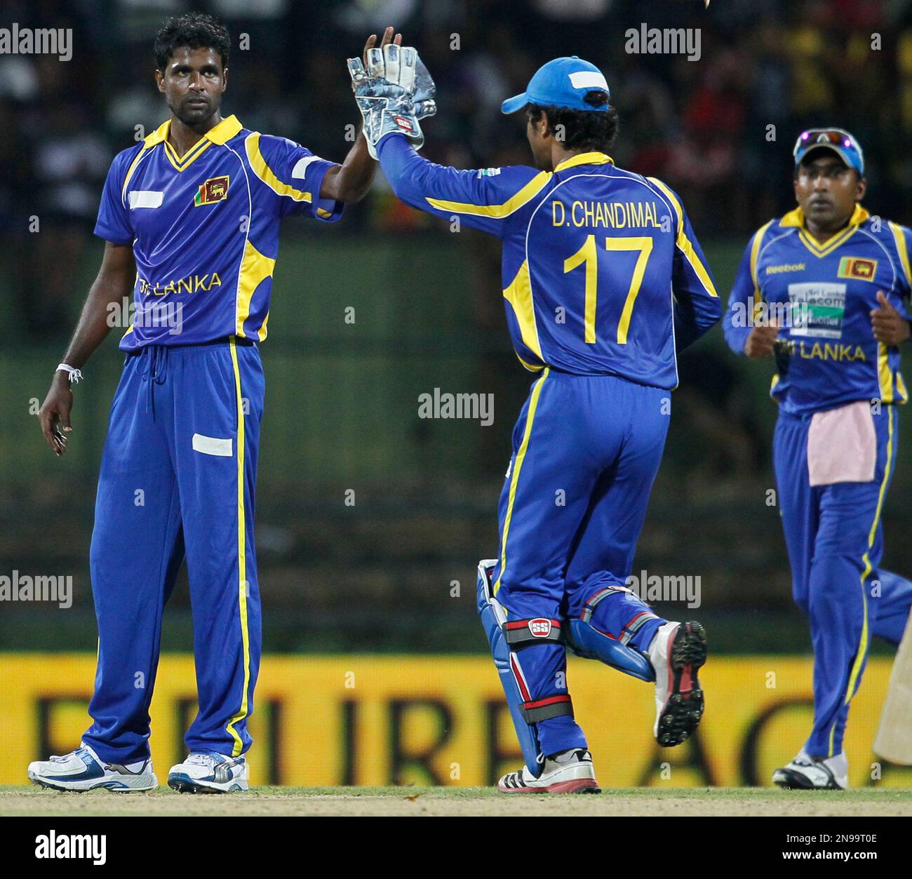 Sri Lanka's bowler Shaminda Eranga, left celebrates the dismissal of ...