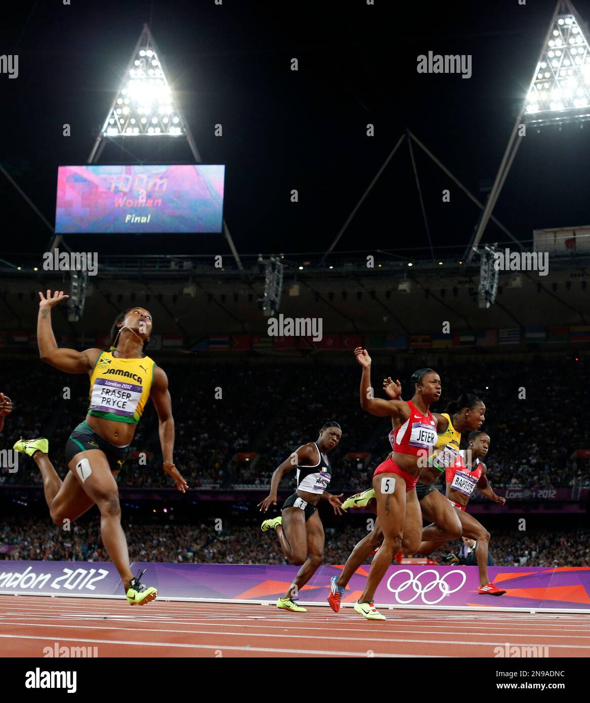 Jamaica's Shelly-Ann Fraser-Pryce, left, crosses the finish line to win gold ahead of United ...