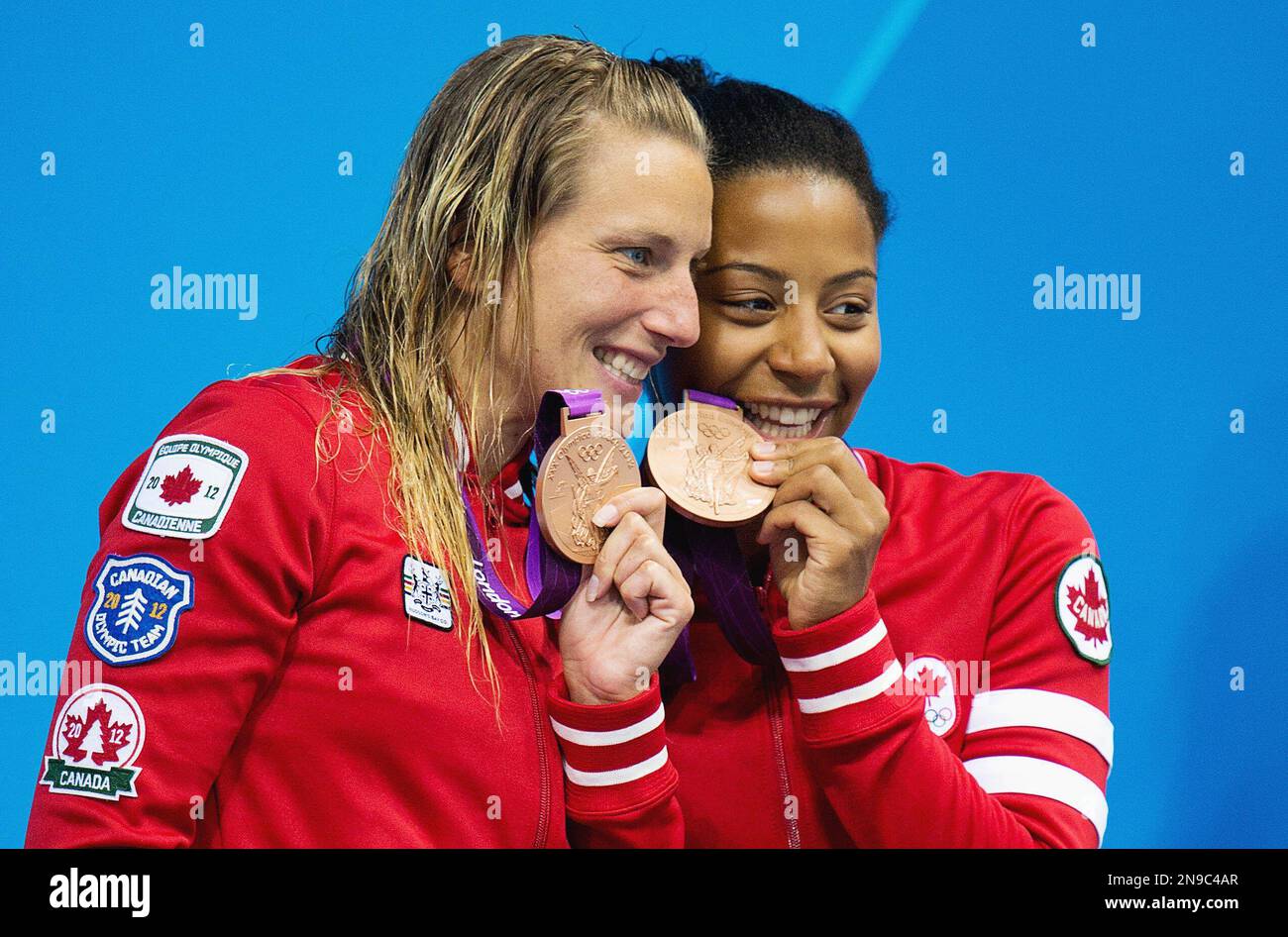 Canada's Emilie Heymans and Jennifer Abel celebrate their bronze medals ...