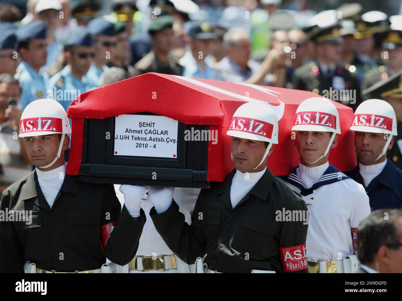 Honour guard soldiers carry the flag-covered coffin of Ahmet Caglar ...