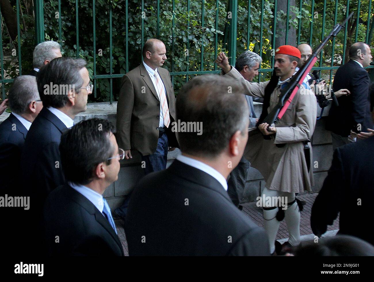 New Greek Prime Minister Antonis Samaras, left third, walks alongside ...