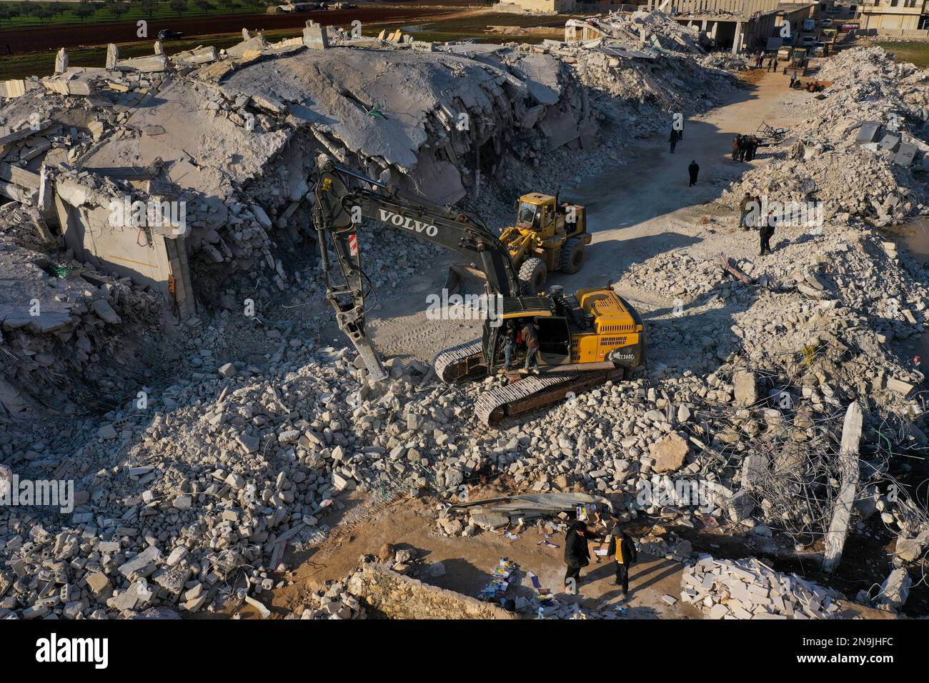 Rescue workers continue to clear rubble from collapsed houses in ...