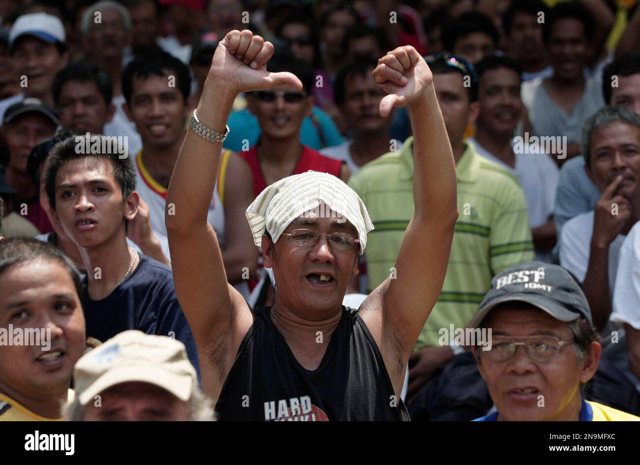 A Filipino fan gestures after hearing the decision in a match between ...