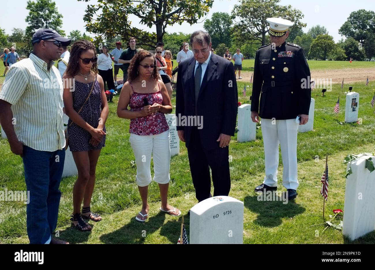 Secretary of Defense Leon Panetta, center right, visits the grave of ...