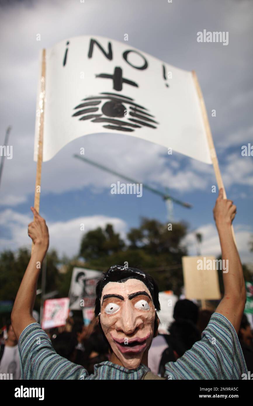 A student holds signs during a demonstration to protest a possible ...