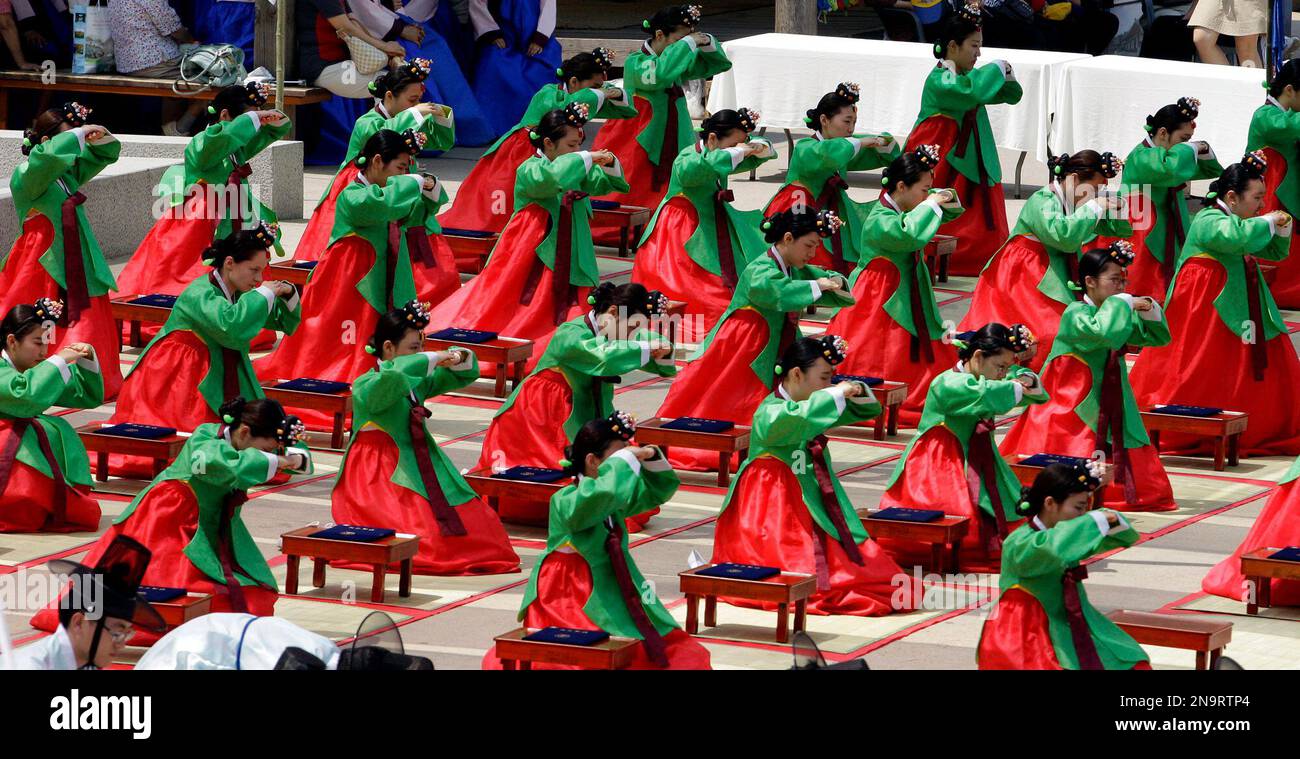 Girls wearing traditional dresses, bow during the 40th Coming of Age ...