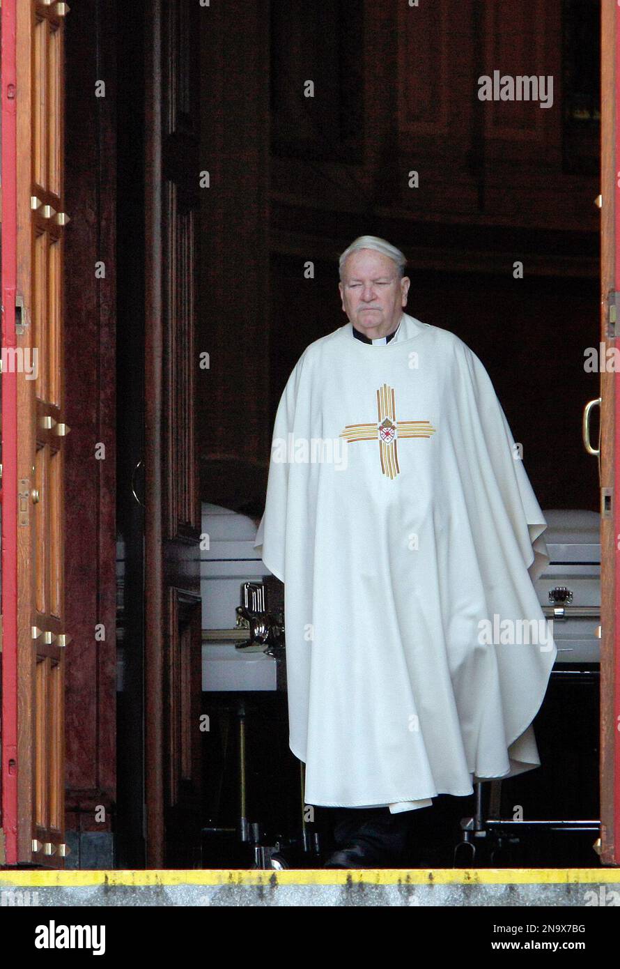 Father William Brogan stands in the door of the Church of St. Raymond ...