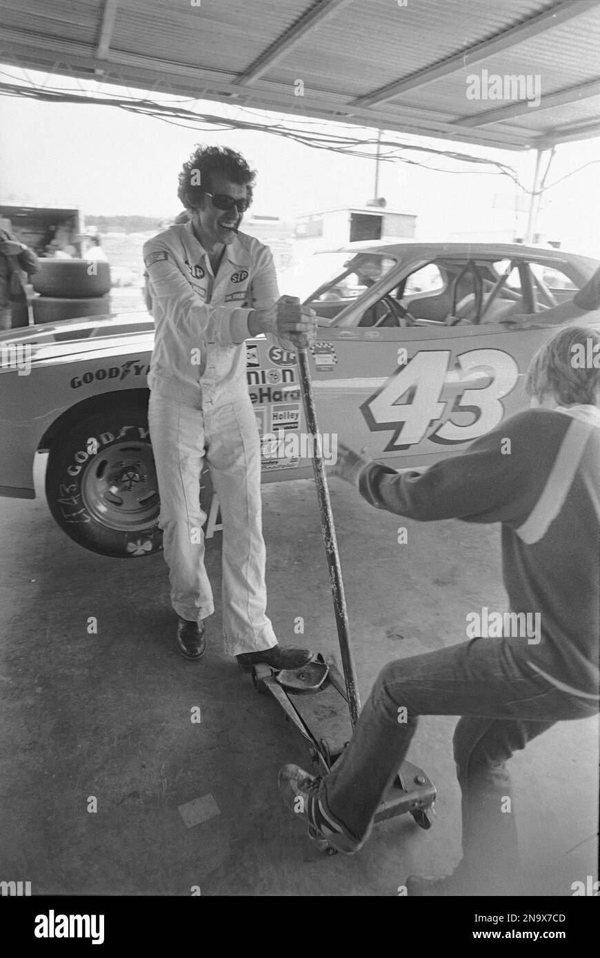 Stock car driver Richard Petty wins a tug of war with a jack handle to ...