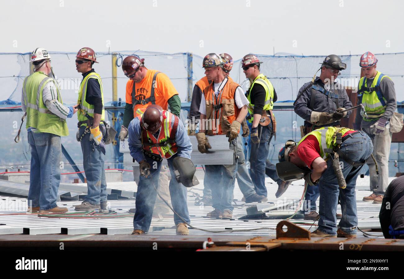 Ironworkers weld steel decking at the top of One World Trade Center on ...