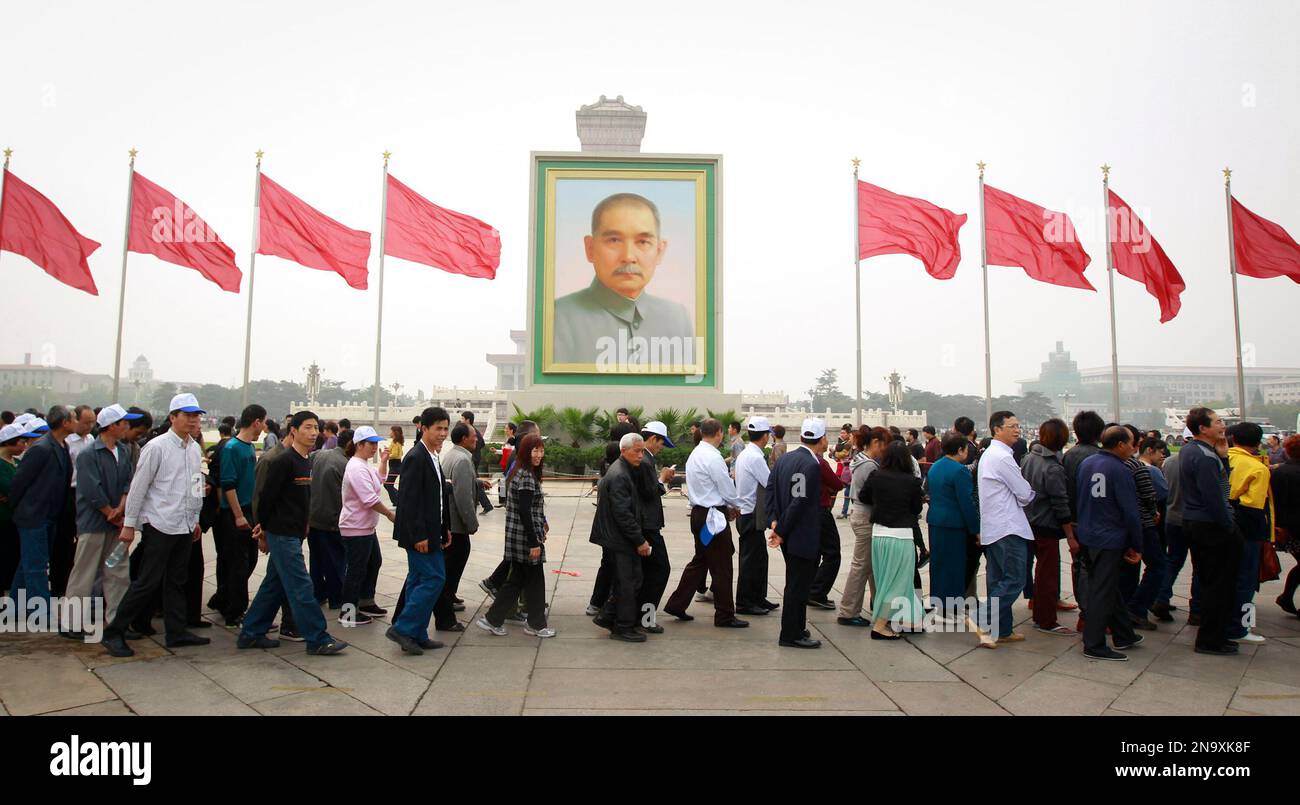 People line up in front of a portrait of Sun Yat-sen, to view the ...