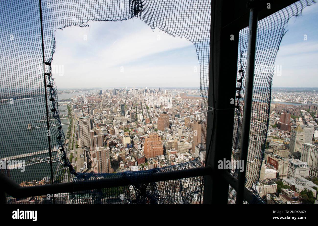 A torn safety net on One World Trade Center provides a window view of ...