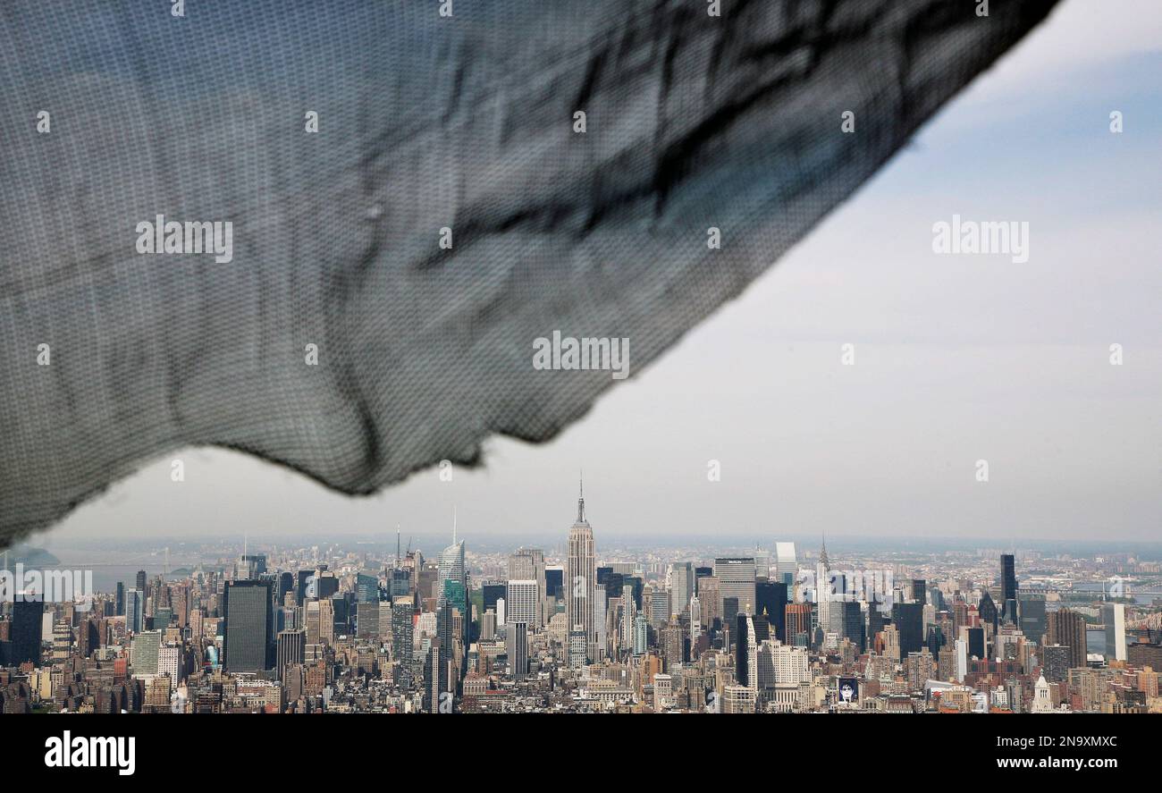 A torn safety net on One World Trade Center provides a window view of ...