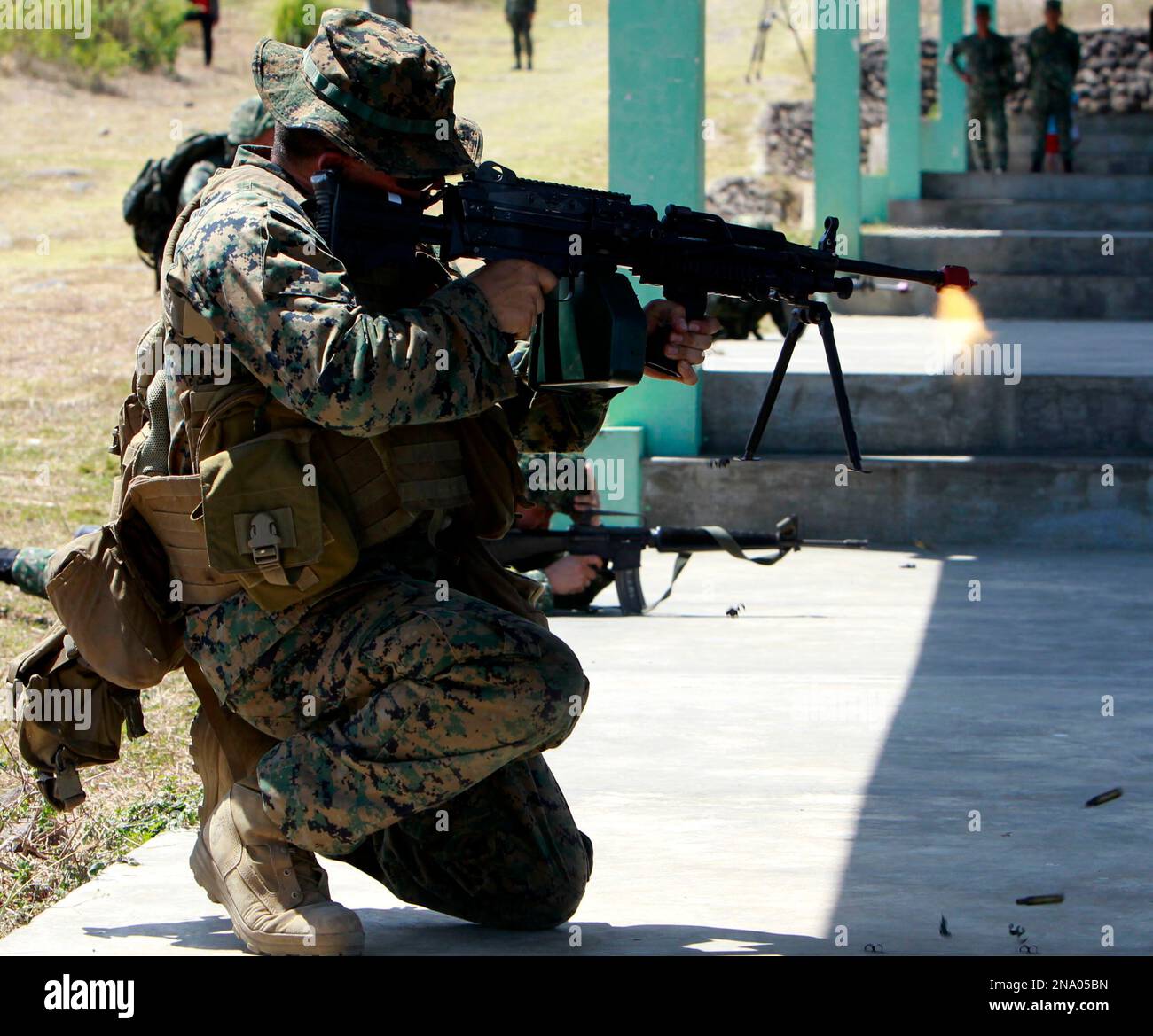 A U.S. Marine fires his rifle during a raid simulation of hostile ...