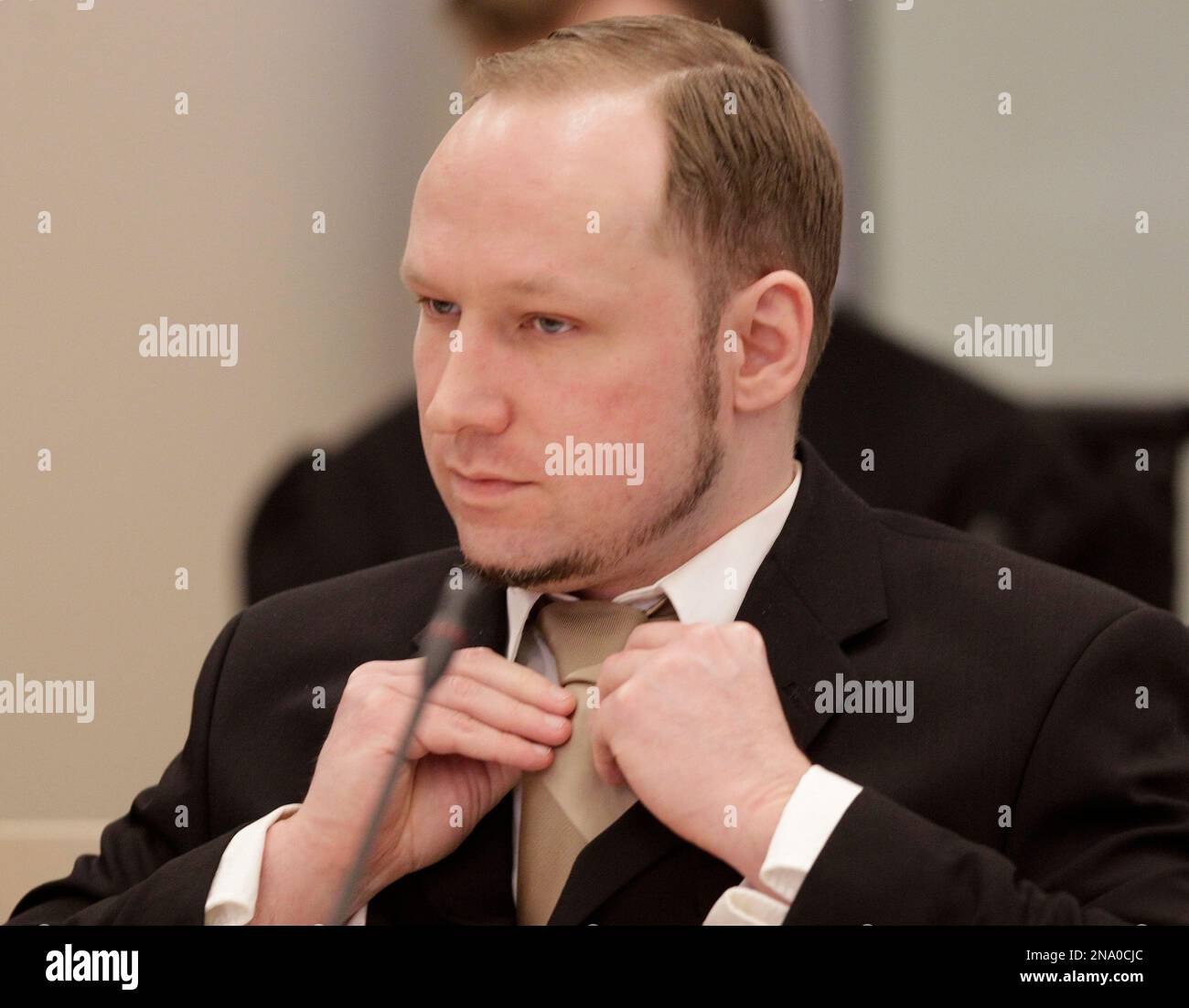Accused Norwegian Anders Behring Breivik adjusts his tie at the ...