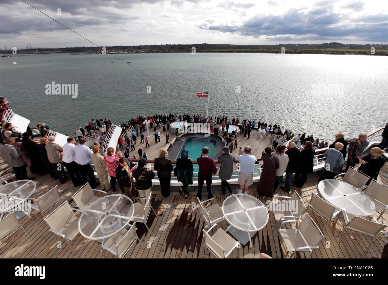 In this photo taken Sunday, April 8, 2012, passengers stand on deck as ...