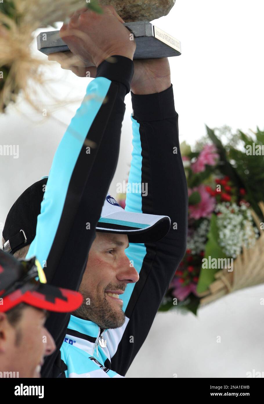 Belgium's Tom Boonen of the Omega Pharma team, holds his trophy on the ...