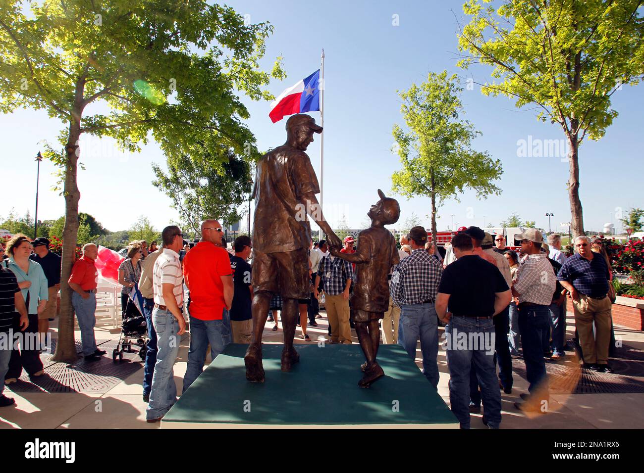 A crowd of fans surround around the statue at Home Plate gate during ...